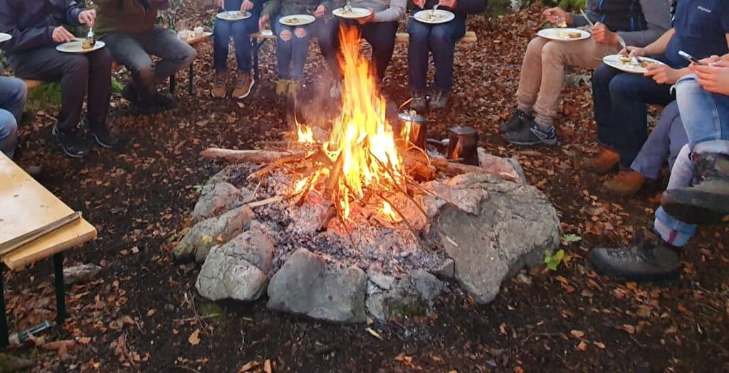 Team cooking around the campfire